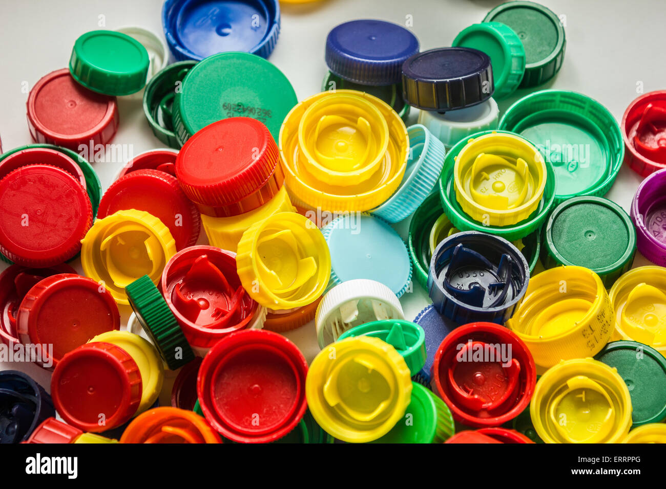 Colorful plastic caps in white background Stock Photo - Alamy