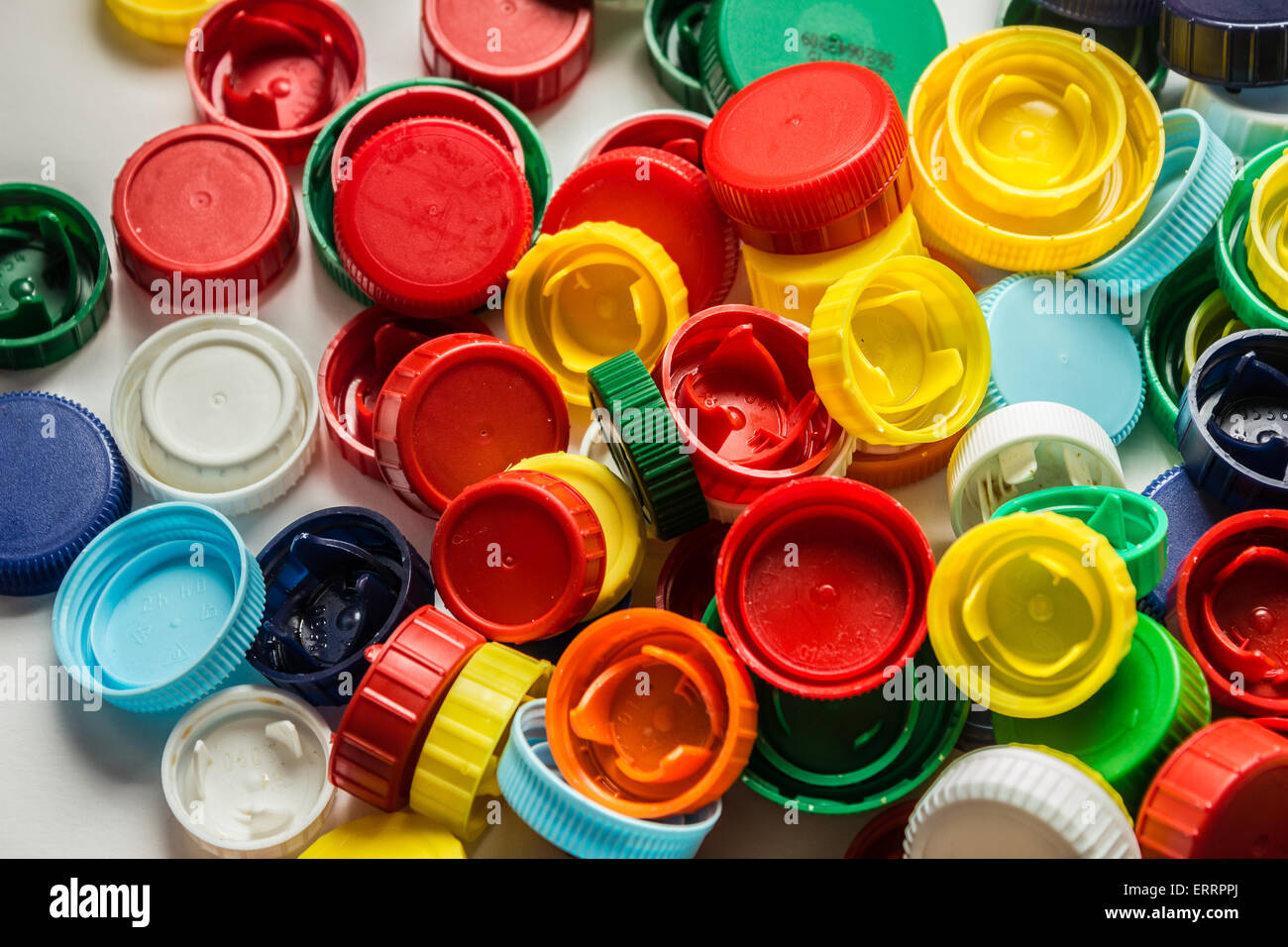 Colorful plastic caps in white background Stock Photo - Alamy