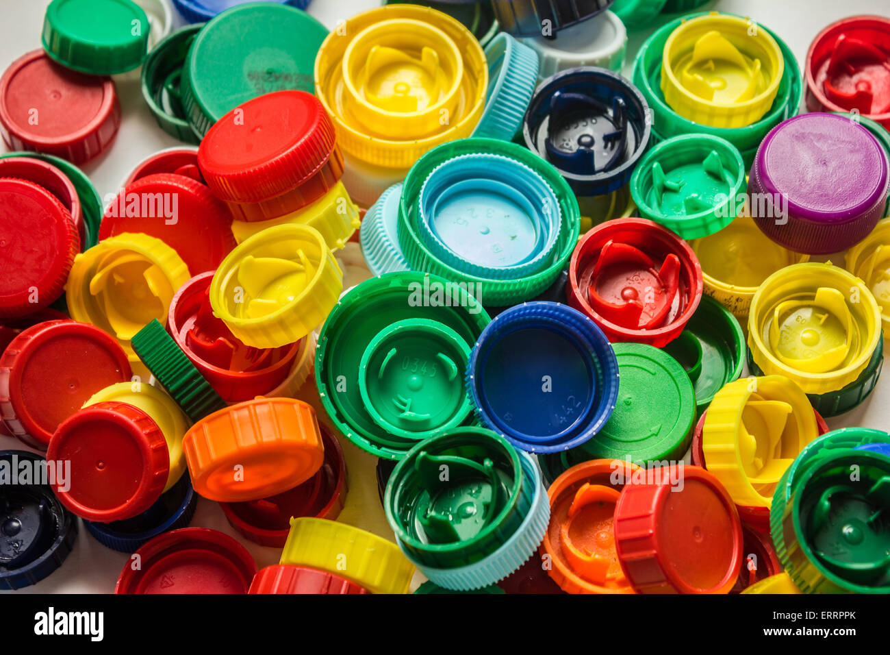 Colorful plastic caps in white background Stock Photo - Alamy