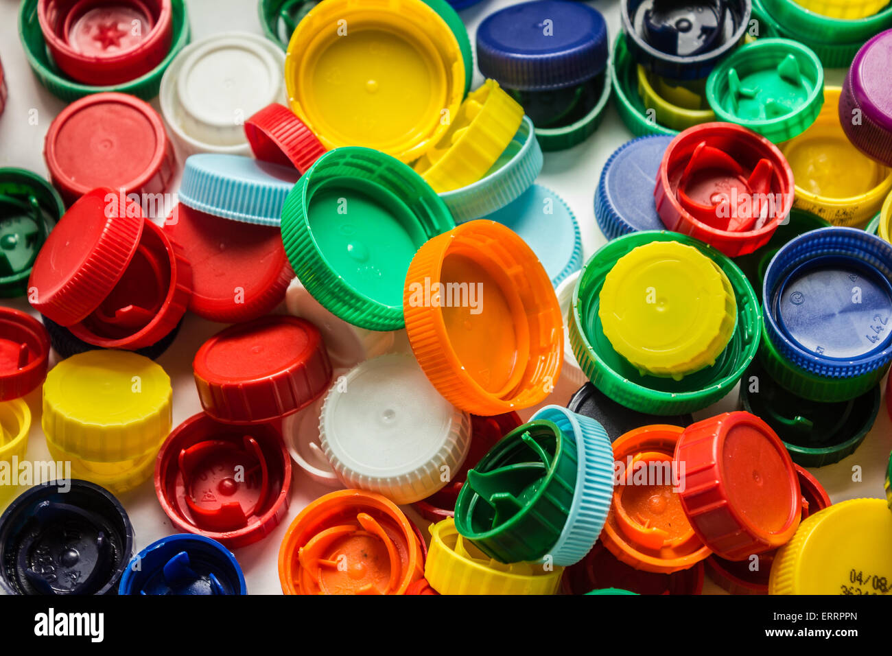 Colorful plastic caps in white background Stock Photo - Alamy