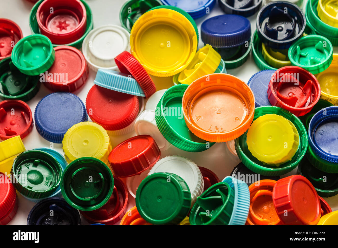Colorful plastic caps in white background Stock Photo - Alamy