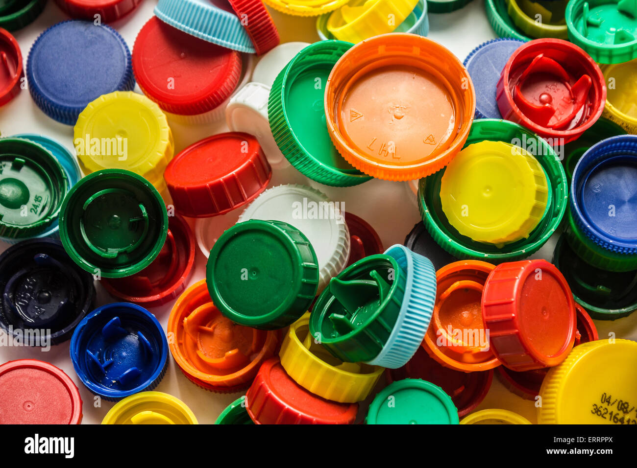 Colorful plastic caps in white background Stock Photo - Alamy