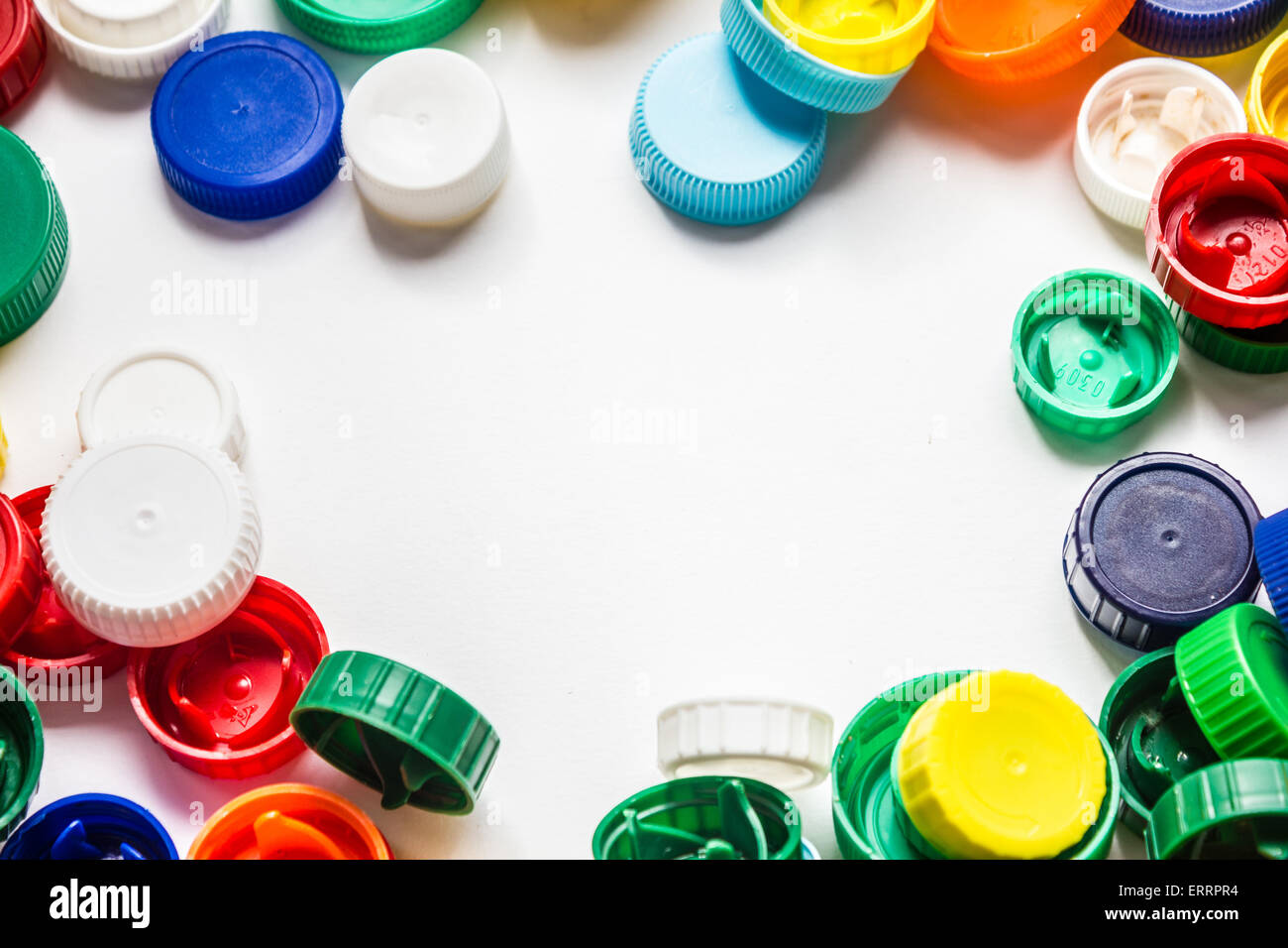 Colorful plastic caps in white background Stock Photo - Alamy