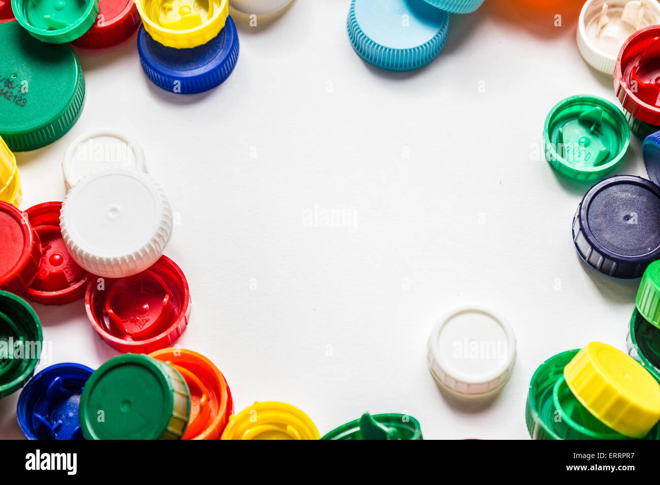 Colorful plastic caps in white background Stock Photo - Alamy