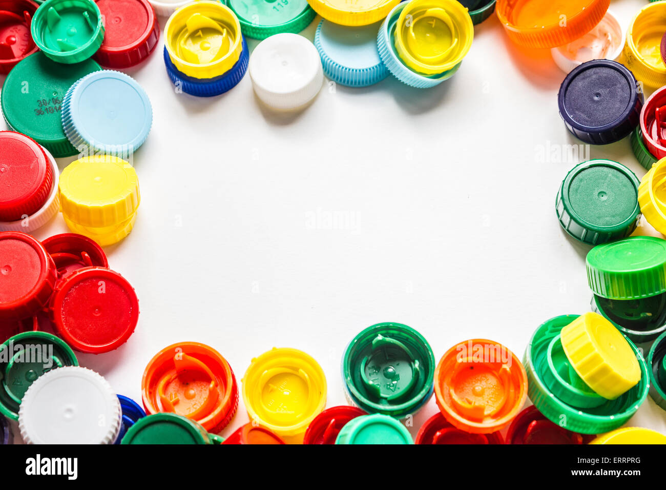Colorful plastic caps in white background Stock Photo - Alamy
