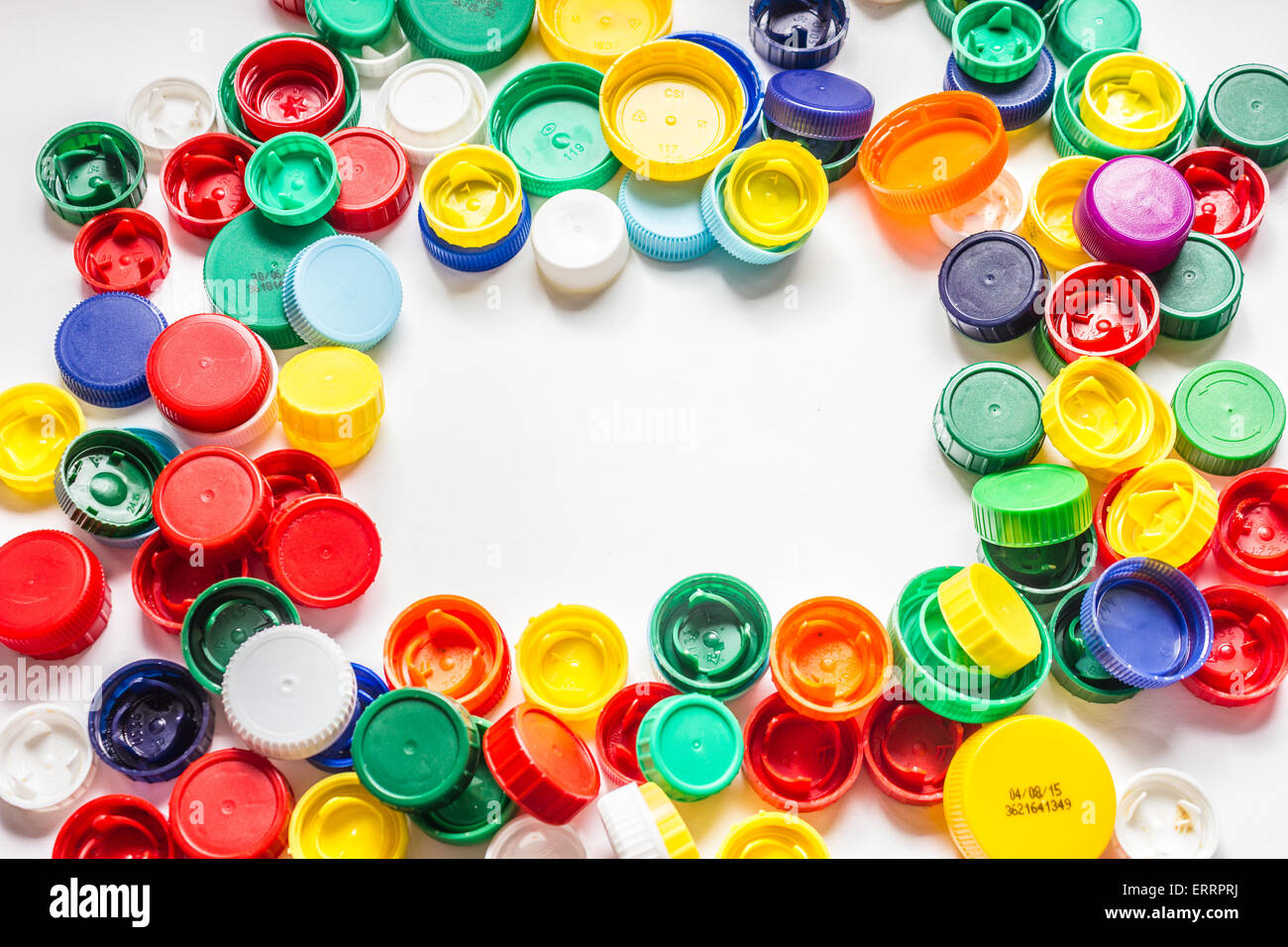 Colorful plastic caps in white background Stock Photo - Alamy
