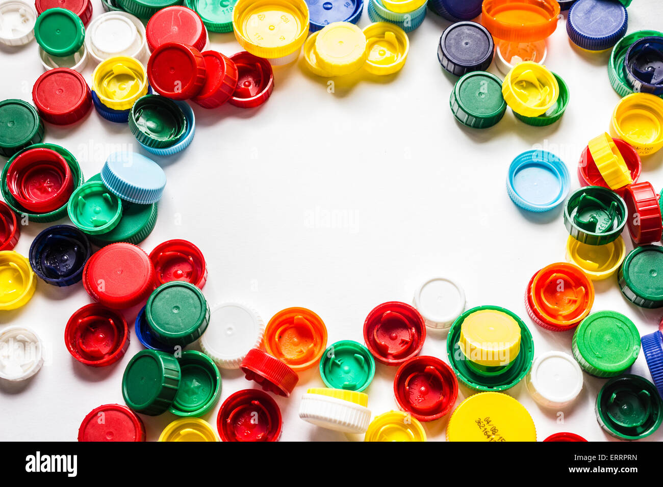 Colorful plastic caps in white background Stock Photo - Alamy