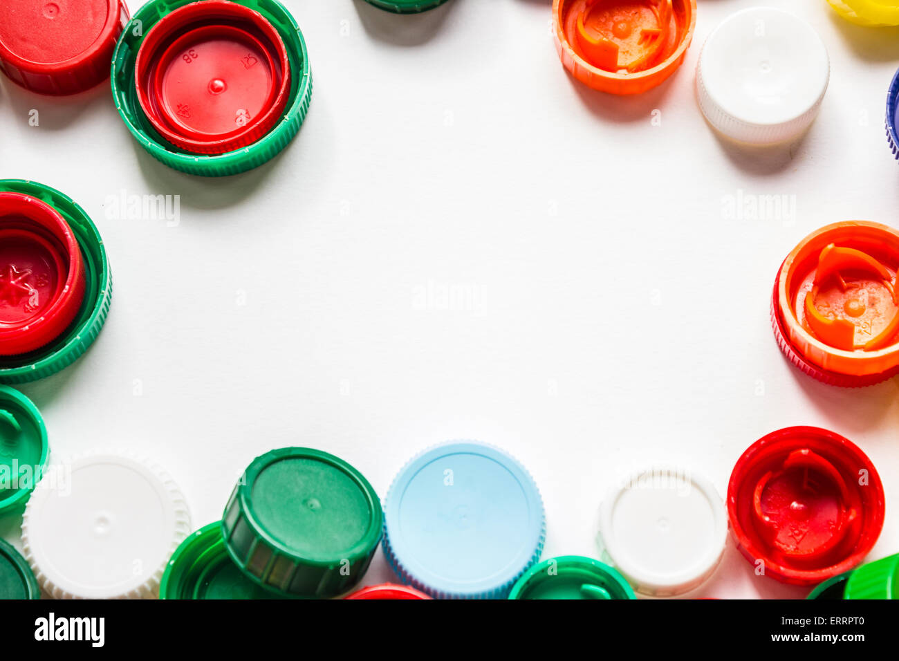 Colorful plastic caps in white background Stock Photo - Alamy