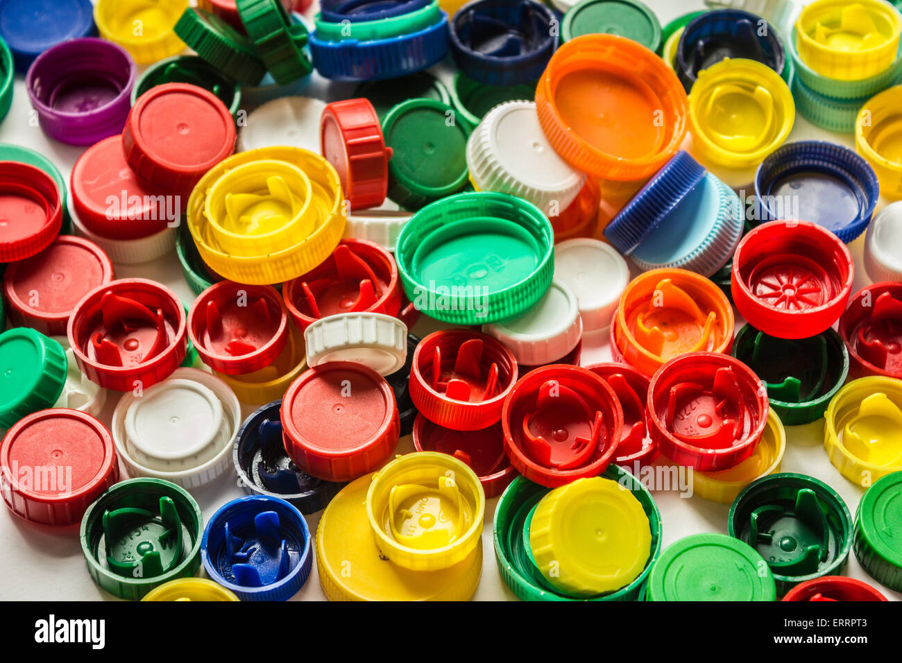 Colorful plastic caps in white background Stock Photo - Alamy