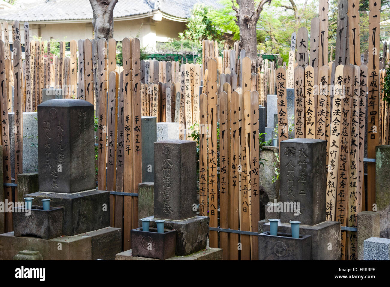 Cramped graveyard, cemetery in Tokyo with gravestones and wooden ...
