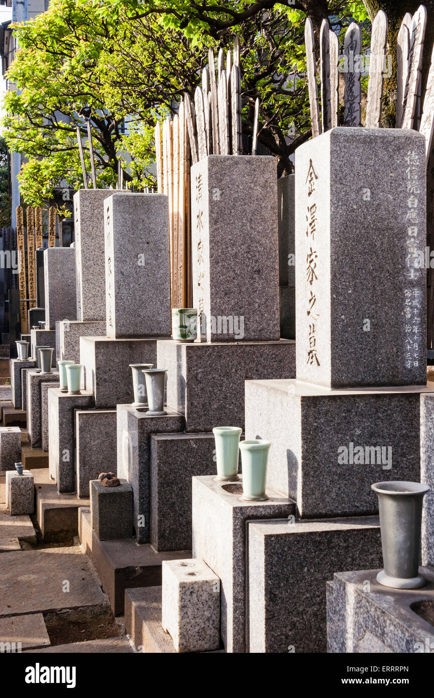 Cramped graveyard, cemetery in Tokyo with gravestones and wooden ...
