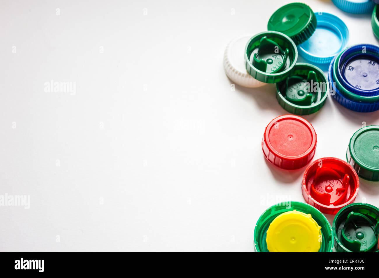 Colorful plastic caps in white background Stock Photo - Alamy
