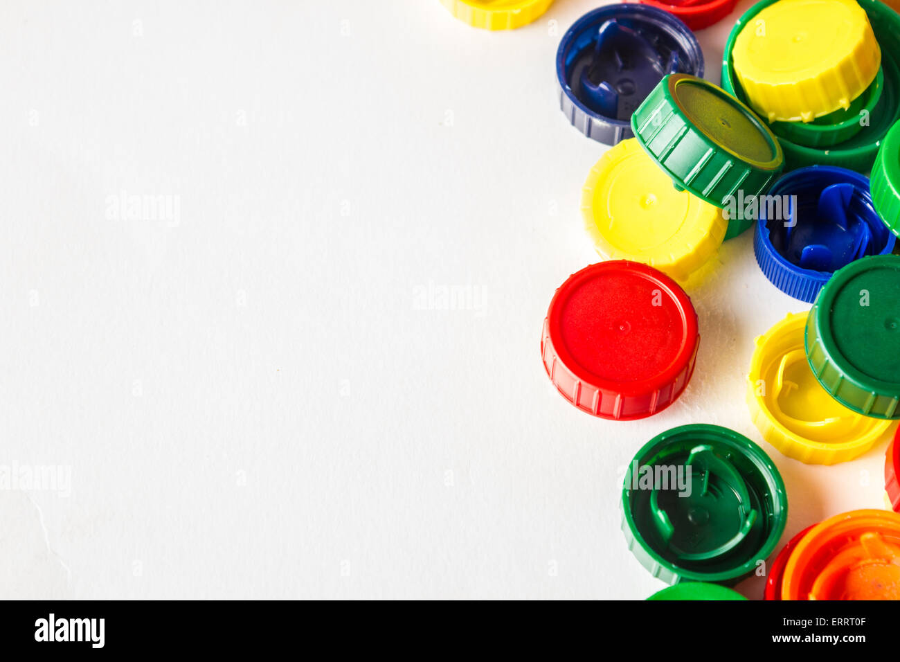 Colorful plastic caps in white background Stock Photo - Alamy