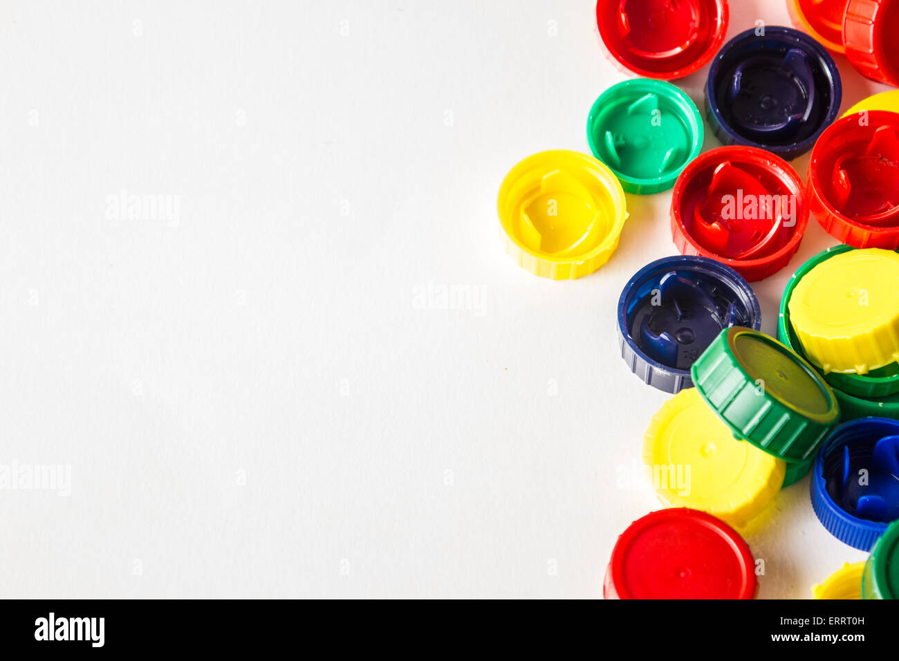 Colorful plastic caps in white background Stock Photo - Alamy