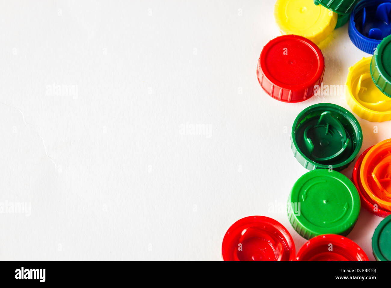 Colorful plastic caps in white background Stock Photo - Alamy
