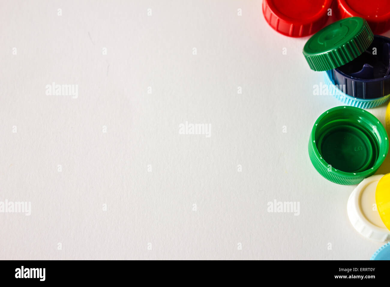 Colorful plastic caps in white background Stock Photo - Alamy