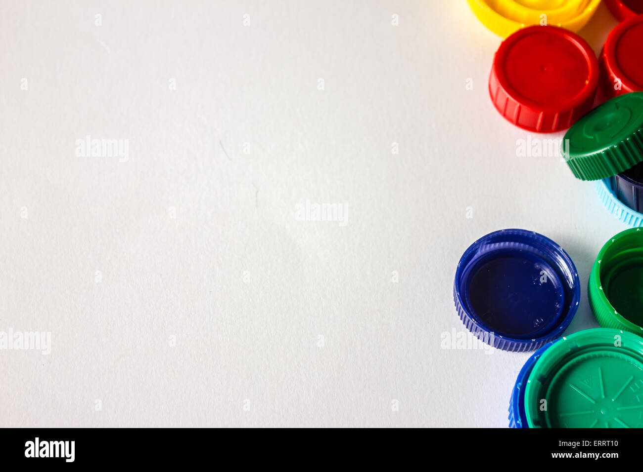 Colorful plastic caps in white background Stock Photo - Alamy