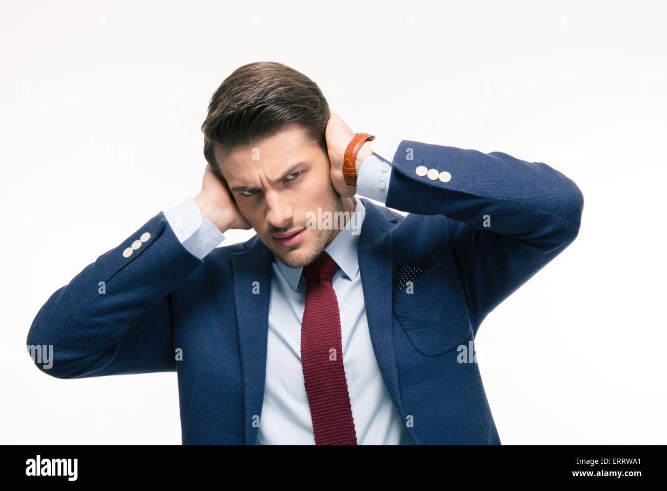 Angry businessman covering his ears isolated on a white background ...