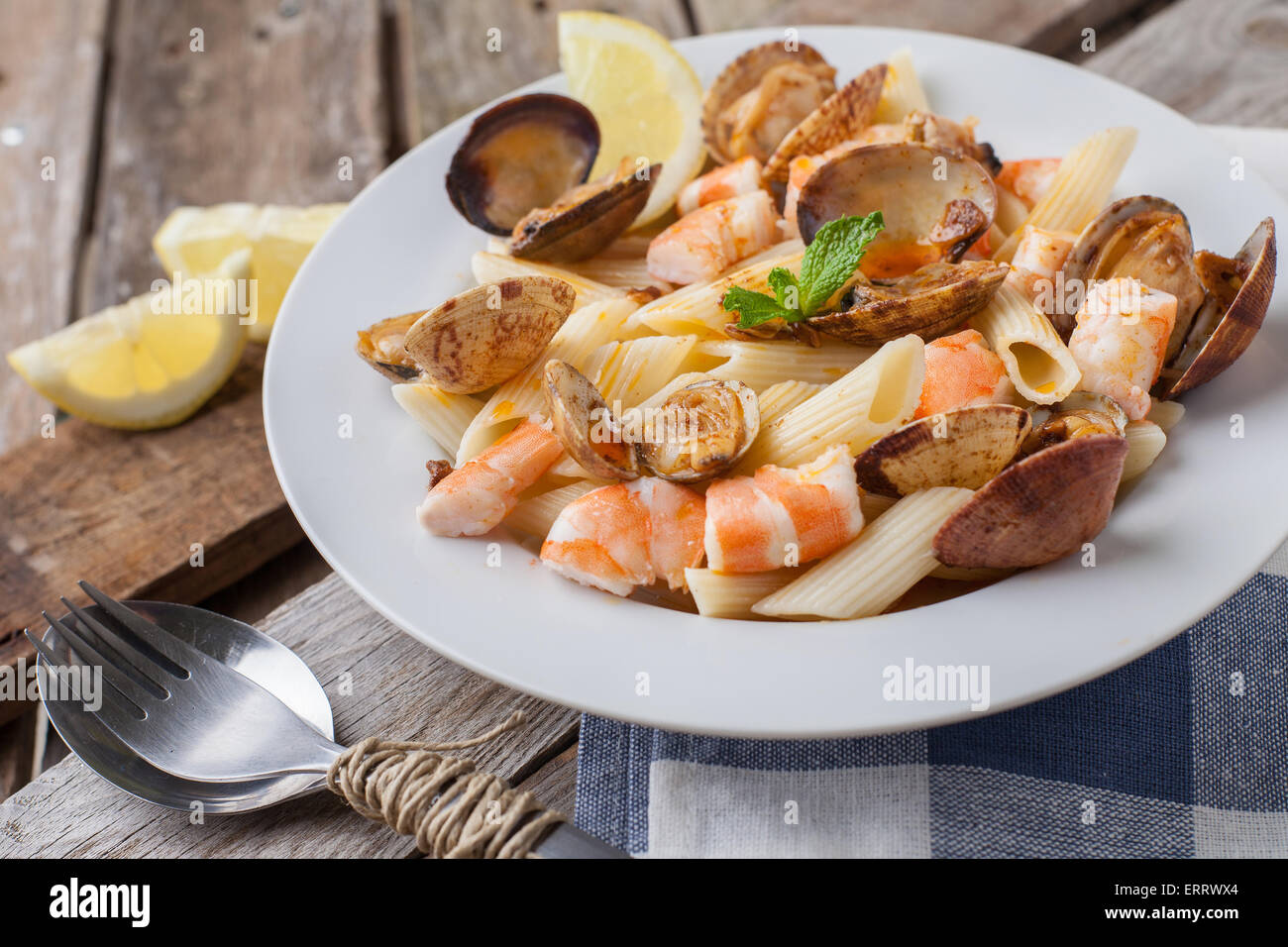 macaroni with prawn and clams at seafood style on white plate Stock ...