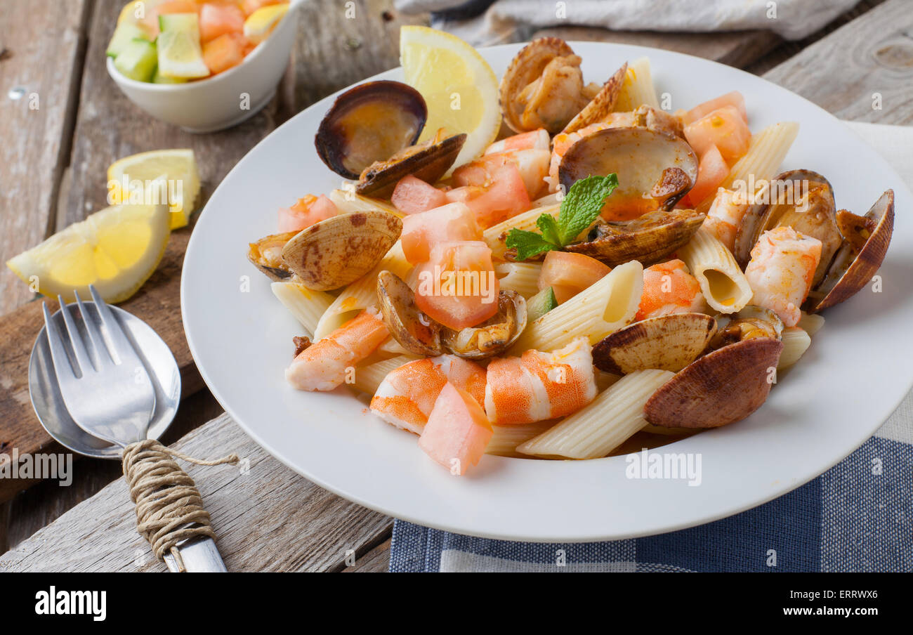 macaroni with prawn and clams at seafood style on white plate Stock ...