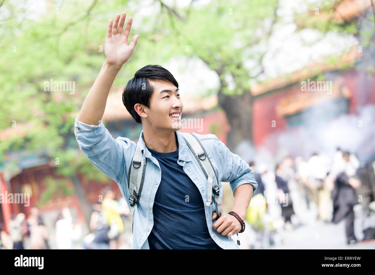 Young man waving Stock Photo - Alamy
