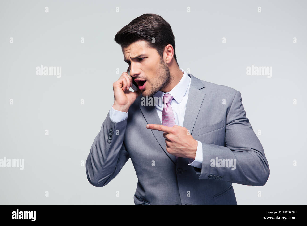 Talking cell hand over mouth hi-res stock photography and images - Alamy