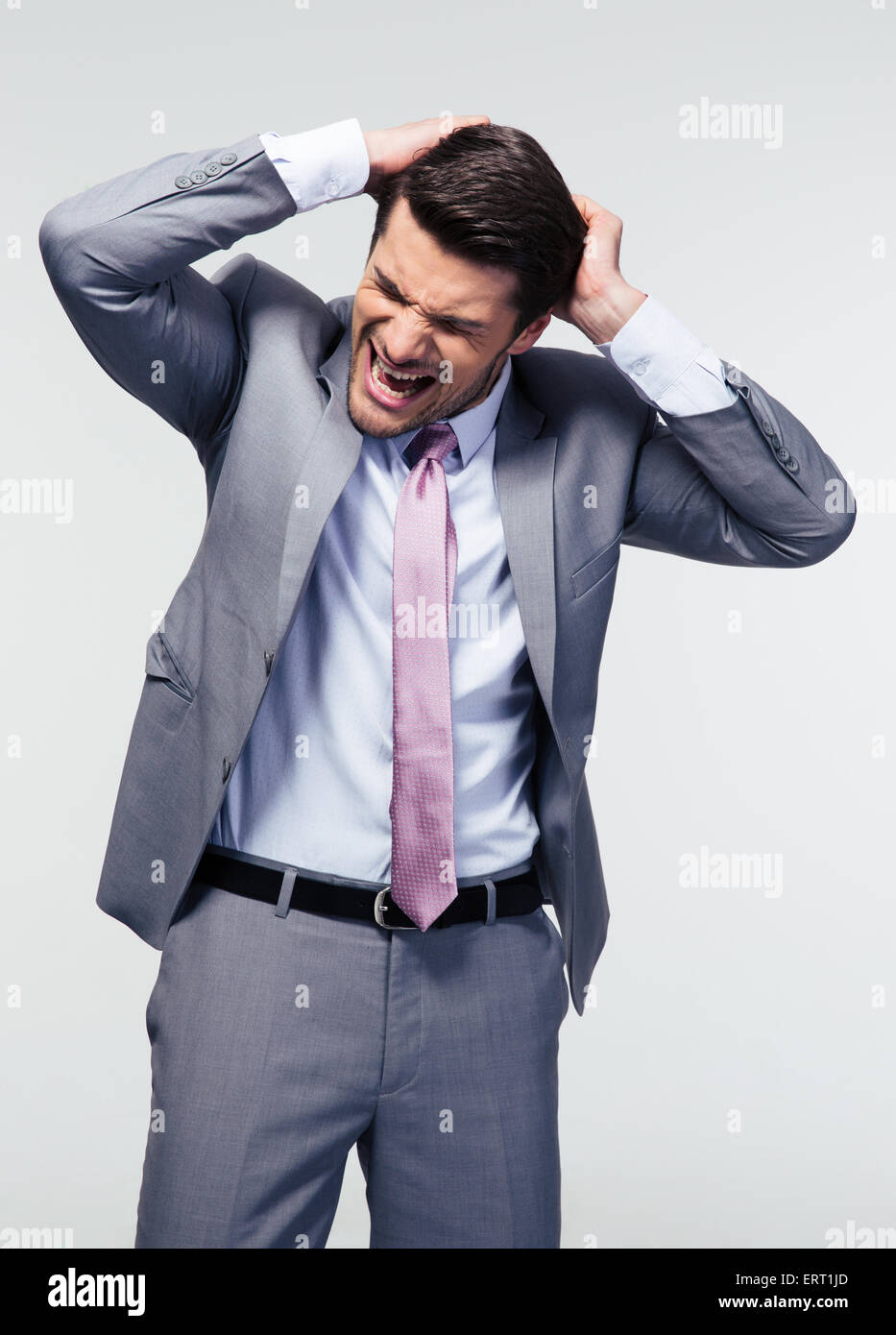 Portrait of a frustrated businessman over gray background Stock Photo ...