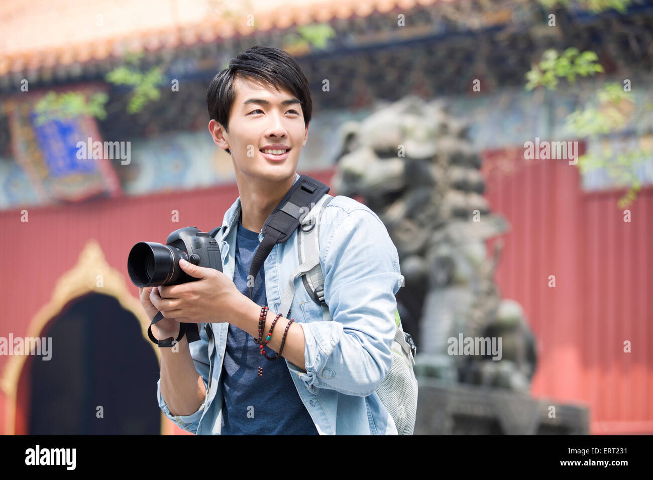 Young man travelling at the Lama Temple with camera Stock Photo - Alamy