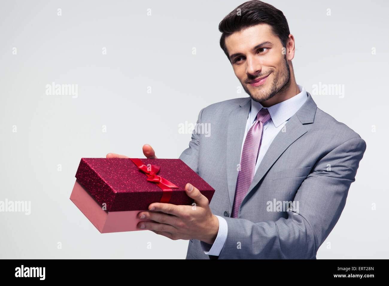 Isolated young man giving something hi-res stock photography and images ...