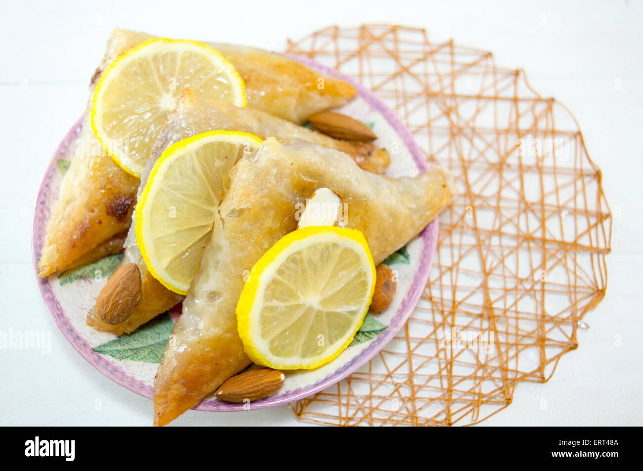 Triangle shaped Turkish Baklava on a plate Stock Photo - Alamy