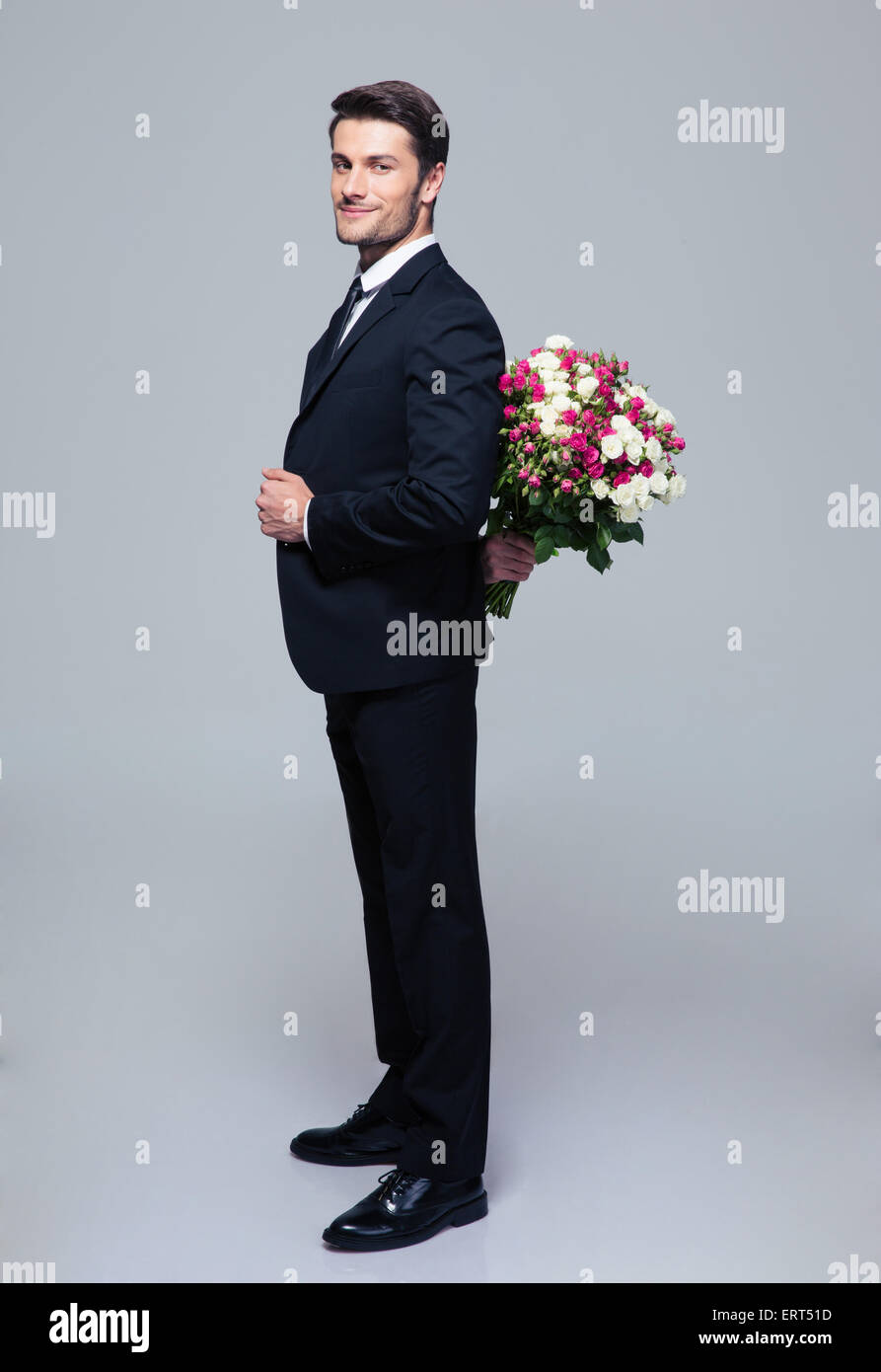 Man hiding rose behind back hi-res stock photography and images - Alamy