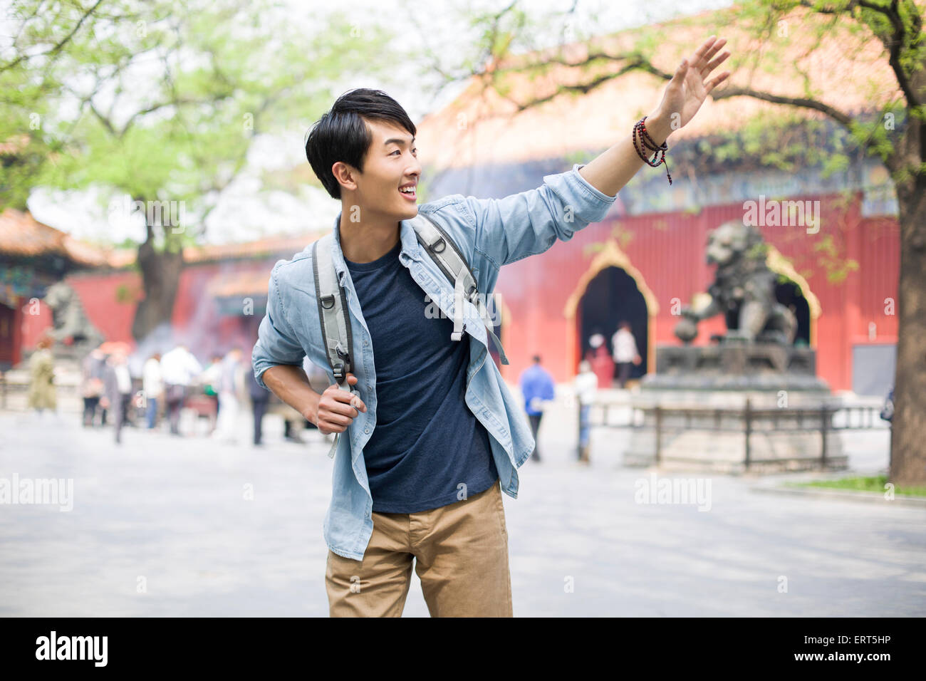 Young man waving Stock Photo - Alamy