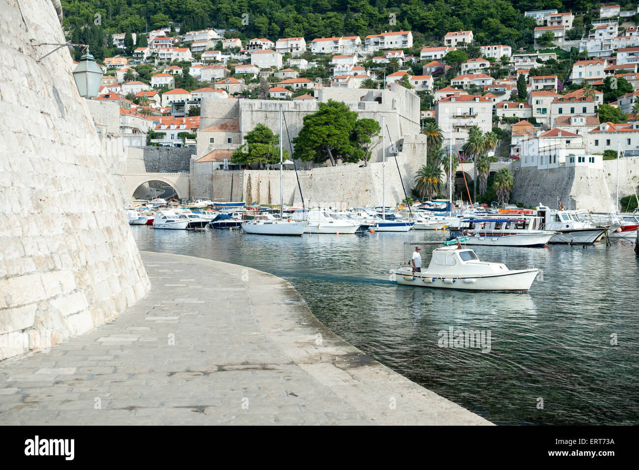 Scenic view of the quiet boat marina under the traditional hillside ...
