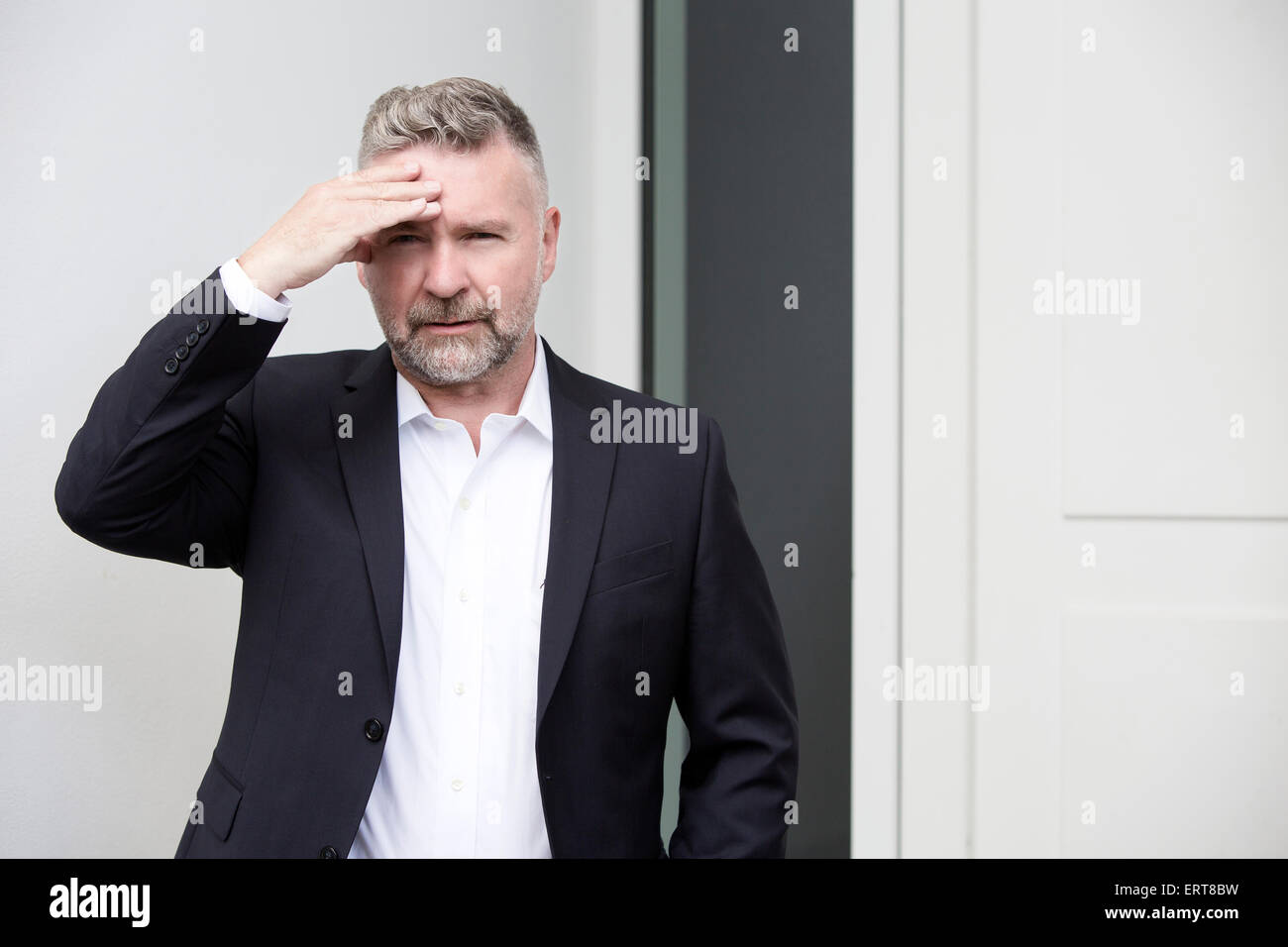 portrait of a businessman with a headache Stock Photo - Alamy
