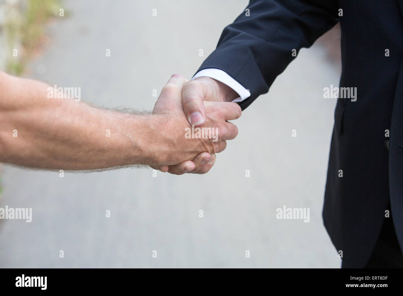 a closeup of a handshake outdoors Stock Photo - Alamy