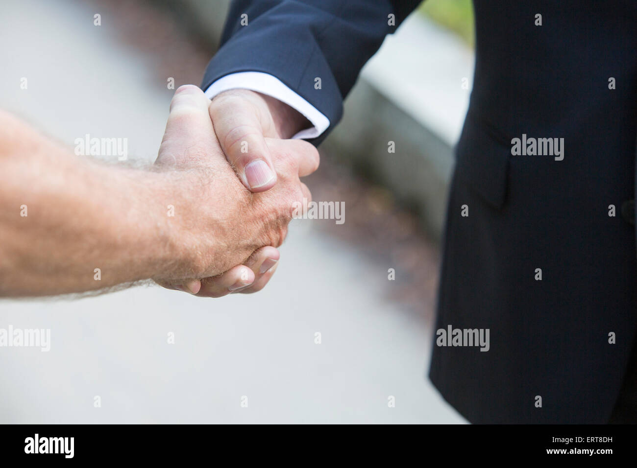 a closeup of a handshake outdoors Stock Photo - Alamy