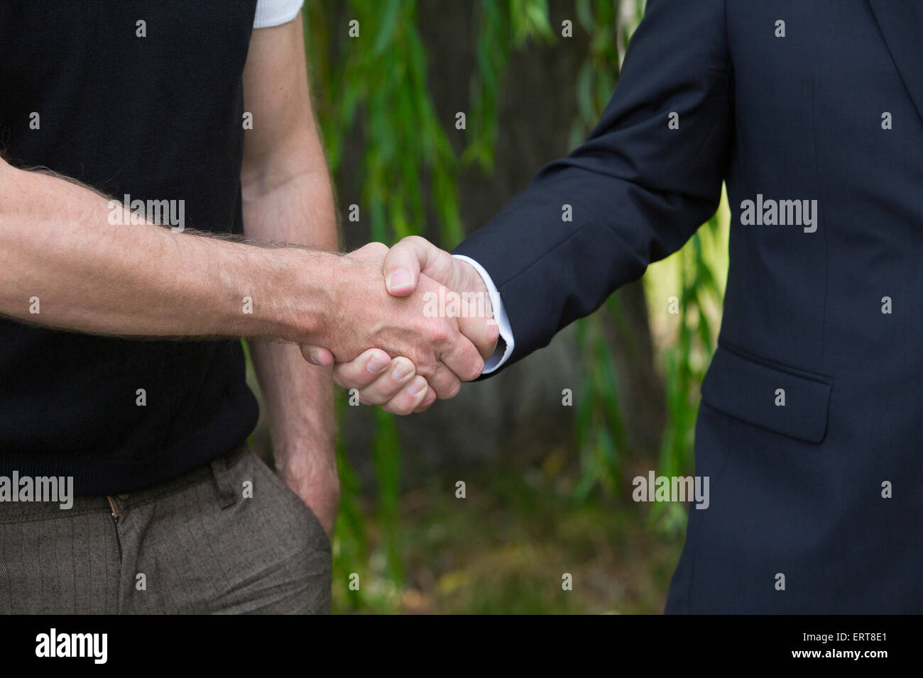 a closeup of a handshake outdoors Stock Photo - Alamy