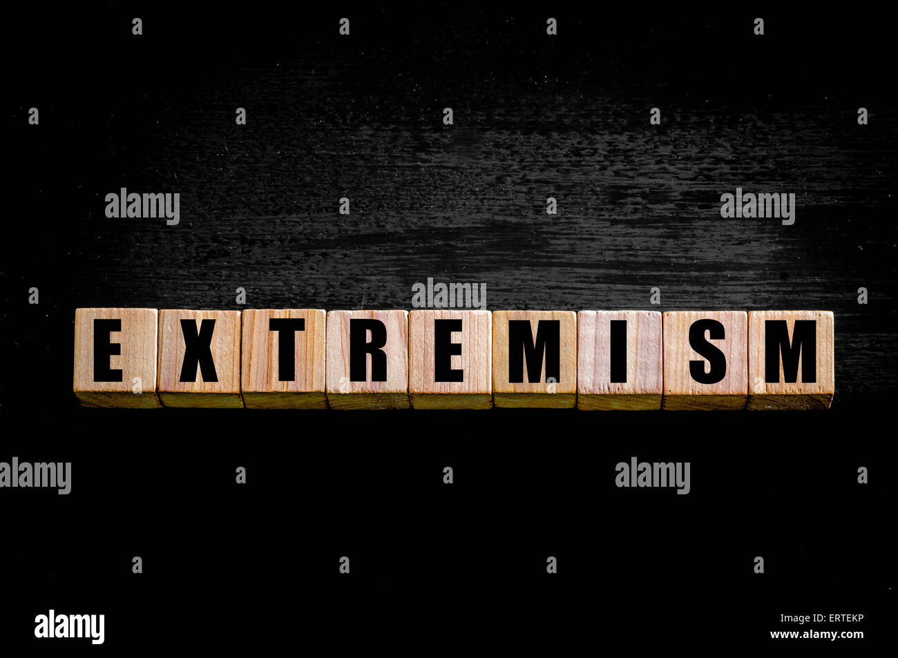 Word EXTREMISM written on wooden small cubes with letters isolated on ...