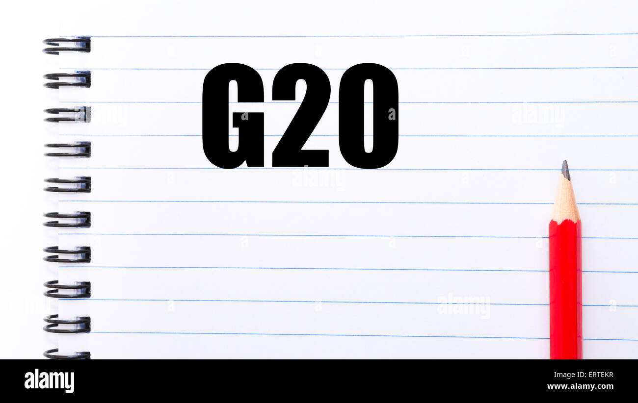 Concept image with word G20 written on notebook page and red pencil on ...