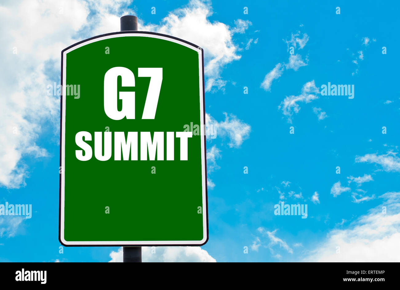 G7 SUMMIT written on green road sign against clear blue sky background ...