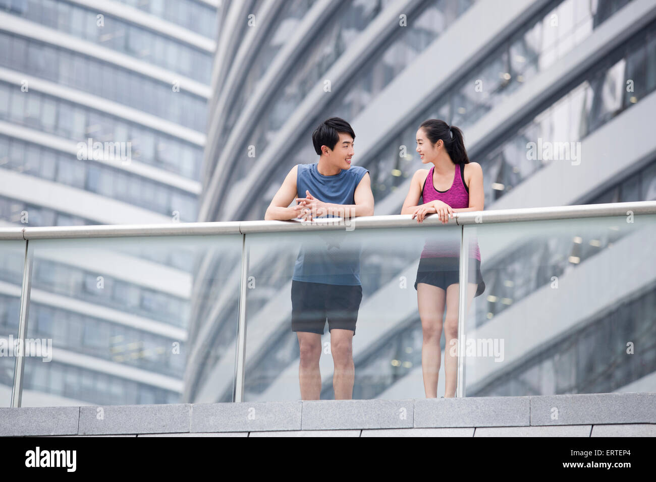 Young couple taking a break from exercise to talk Stock Photo - Alamy