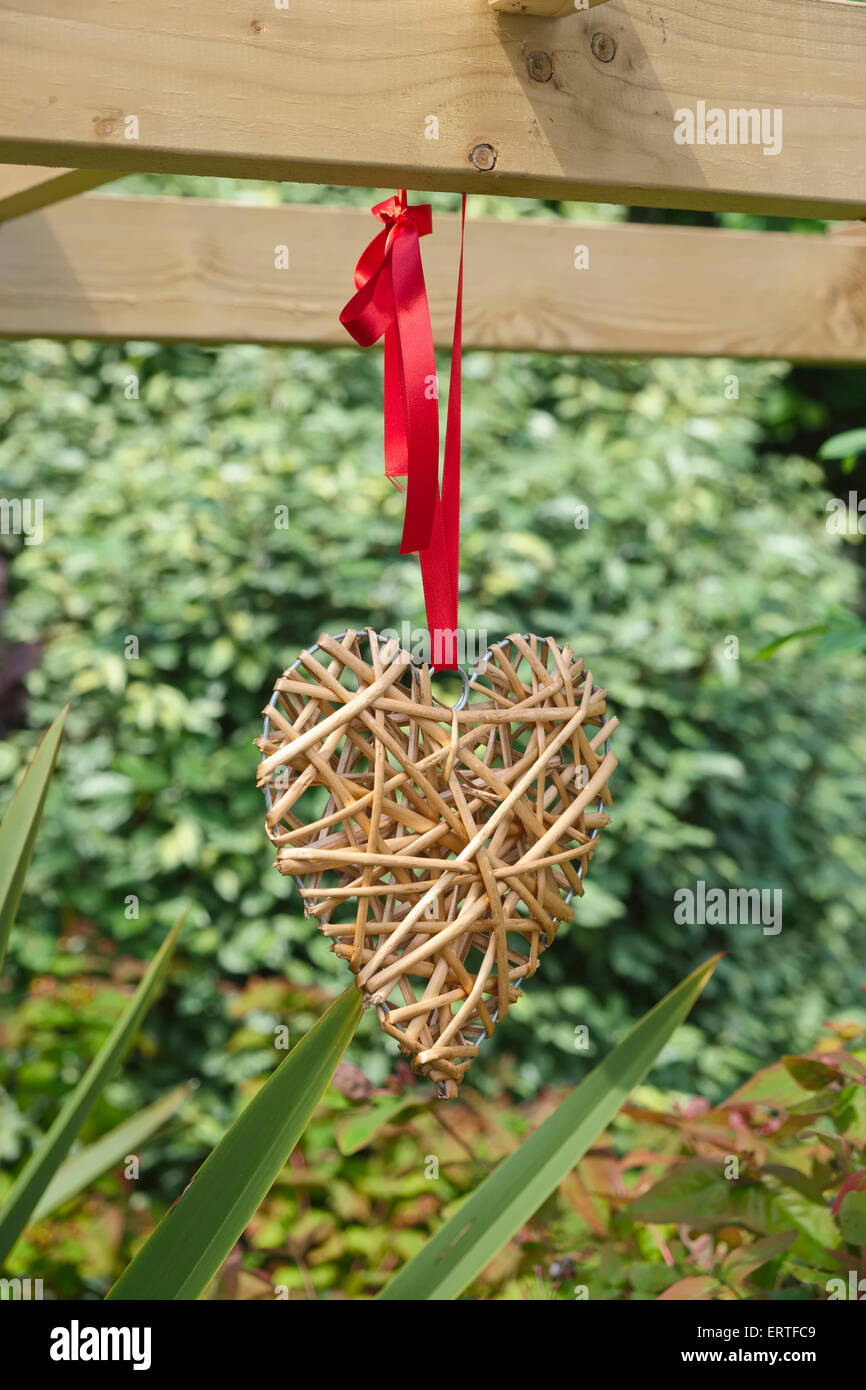 Wicker Heart Hanging in Garden Stock Photo - Alamy