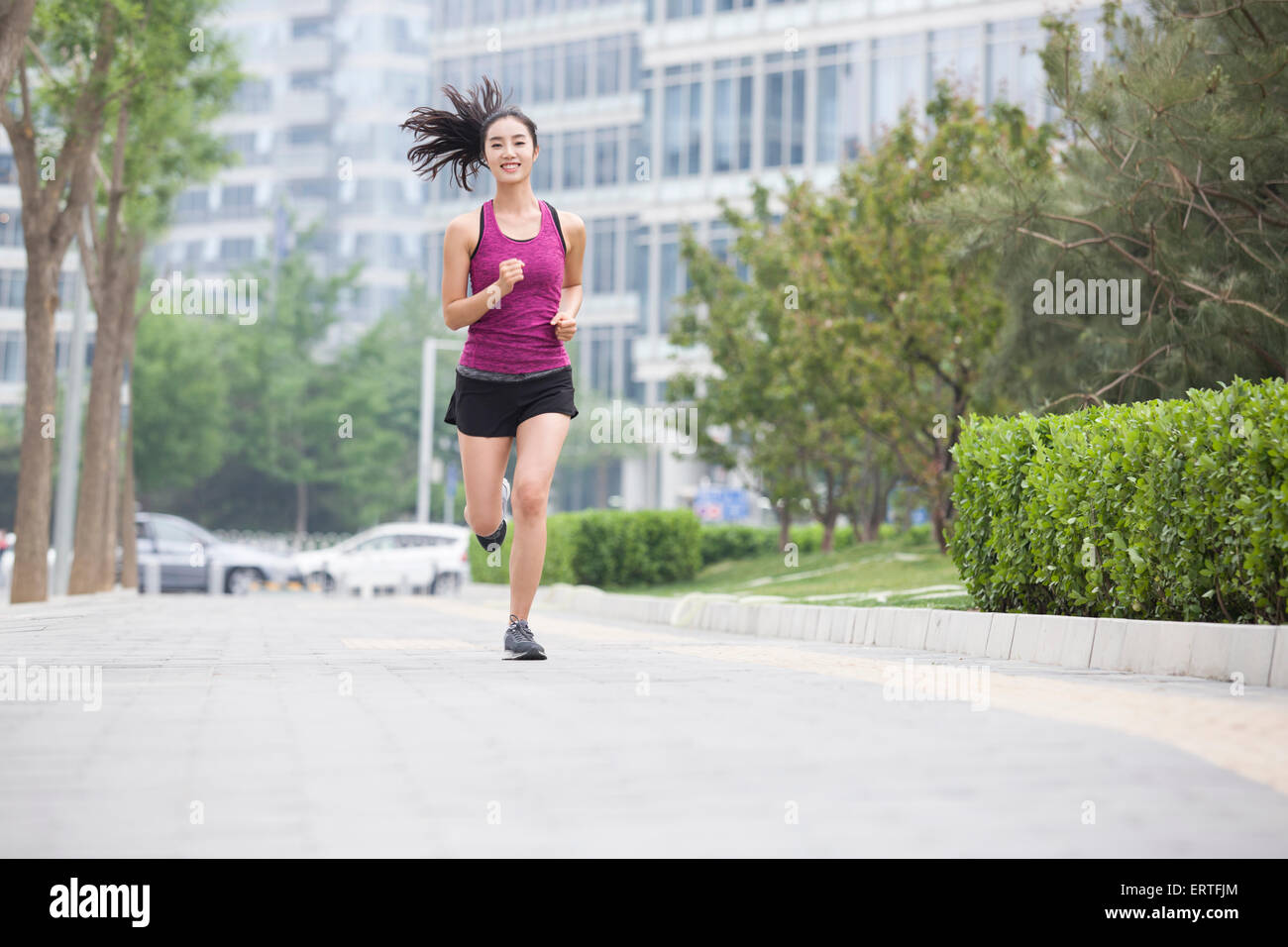 Young woman running outside Stock Photo - Alamy