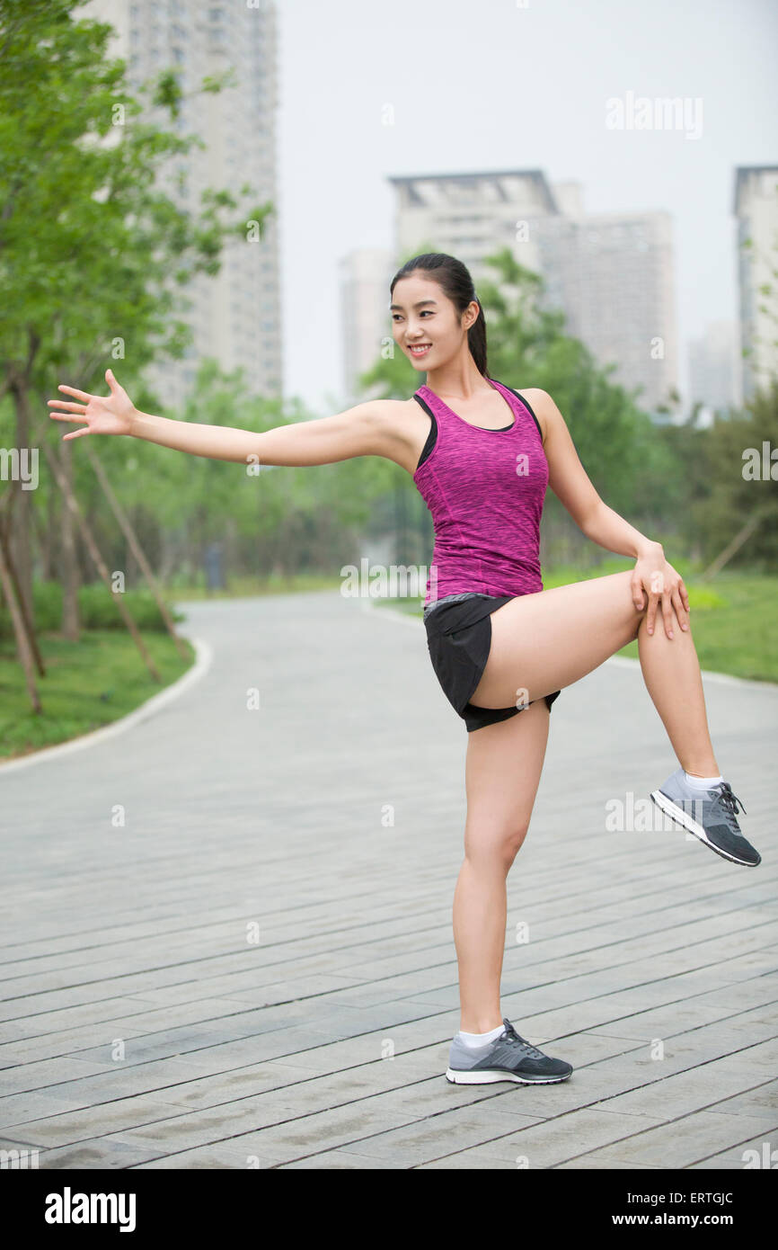 Young woman stretching outside Stock Photo - Alamy