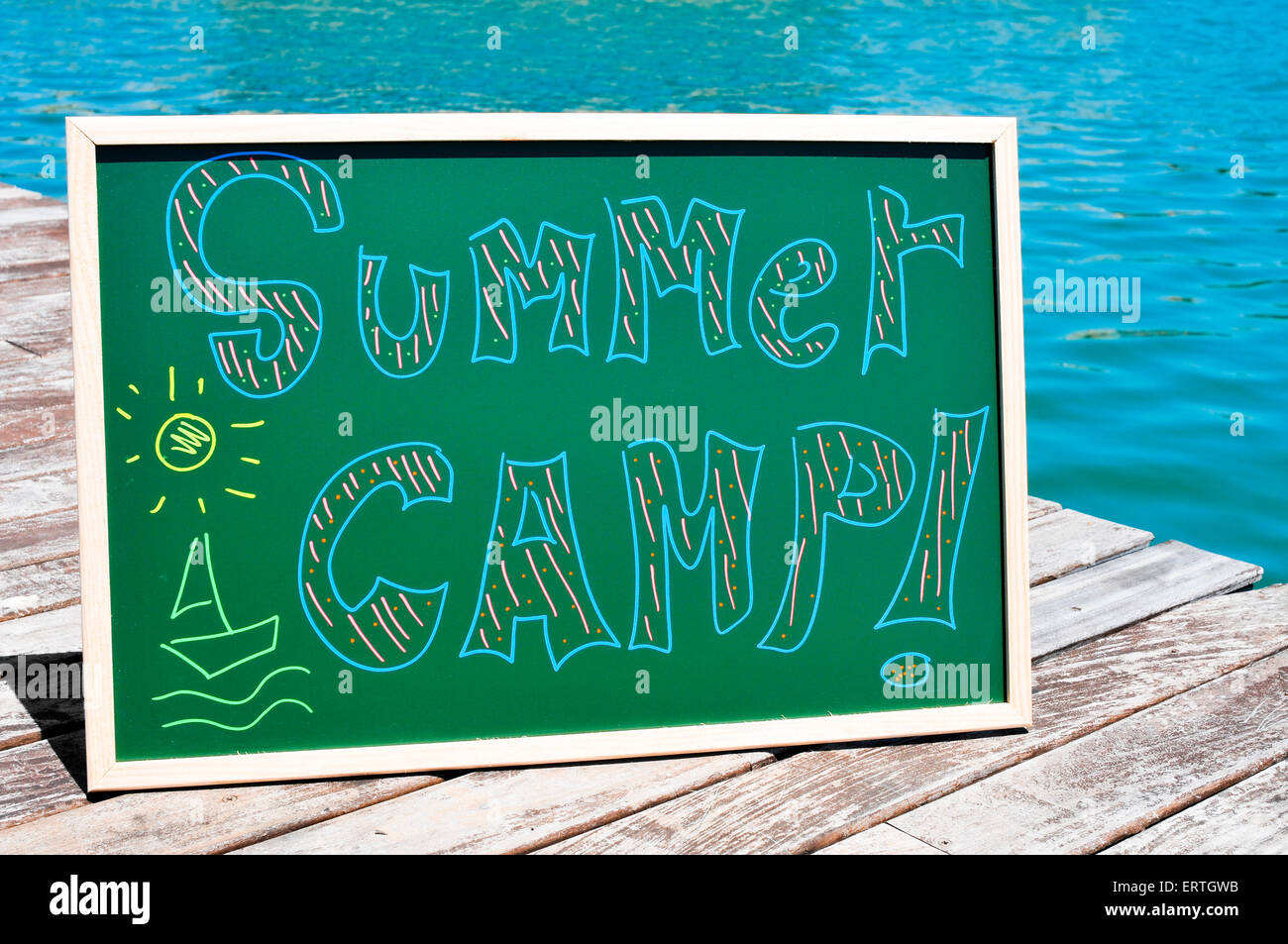 the text summer camp written with chalk of different colors in a ...