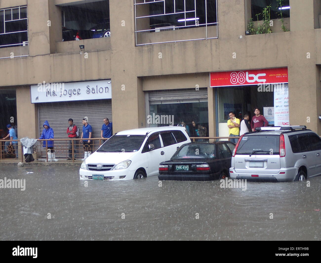 Quezon City, Philippines. 08th June, 2015. Submerged vehicles in gutter ...