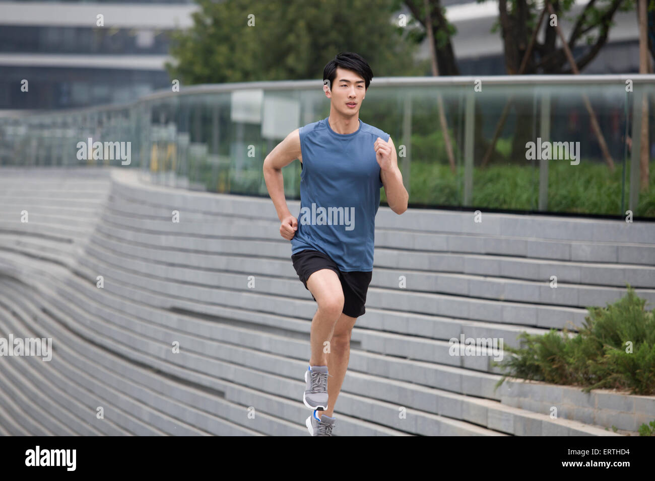 Young man running outside Stock Photo - Alamy