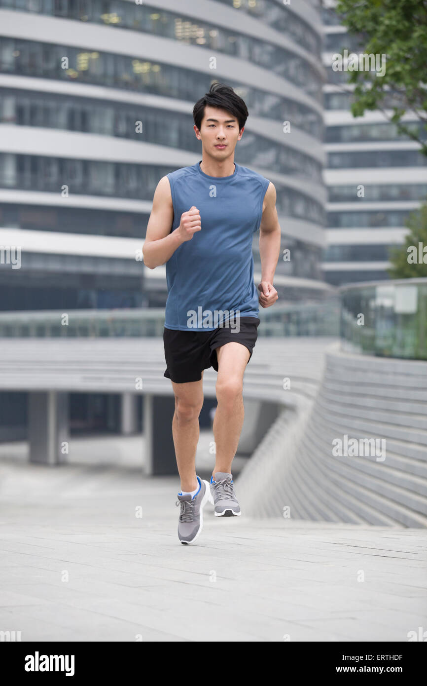 Young man running outside Stock Photo - Alamy