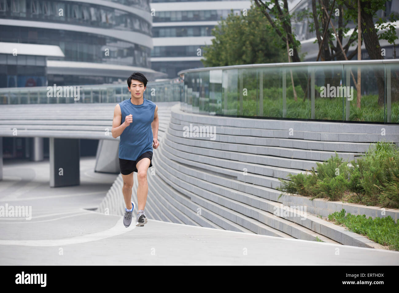 Young man running outside Stock Photo - Alamy