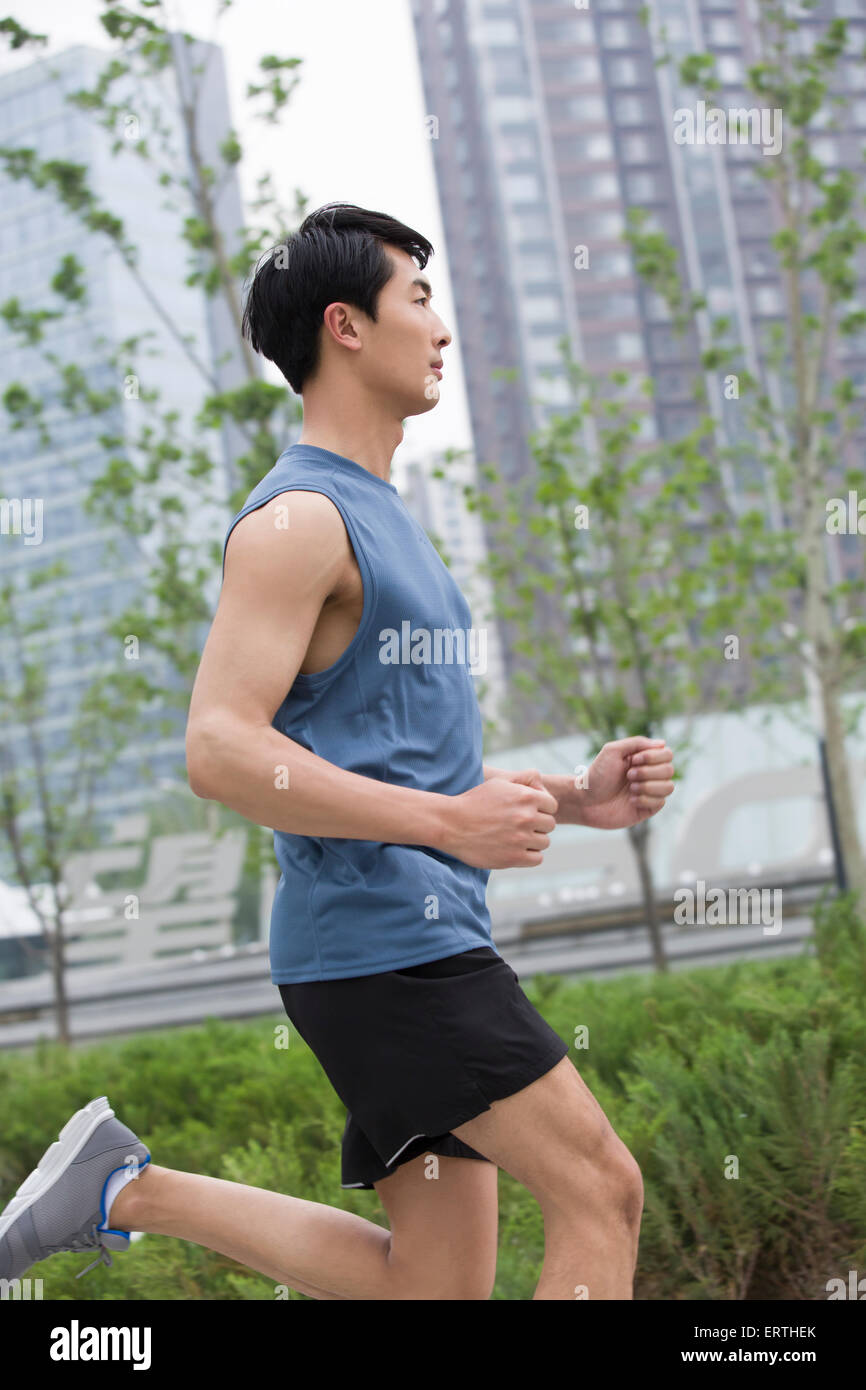 Young man running outside Stock Photo - Alamy
